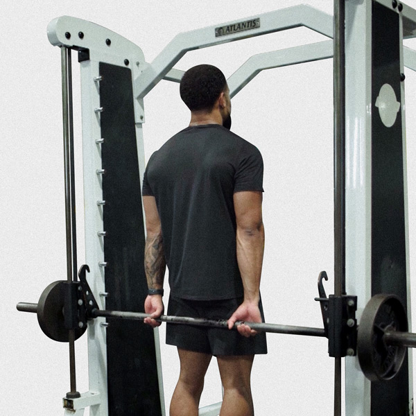 Smith Machine Behind Back Shrug - Exercise Guide | Motra